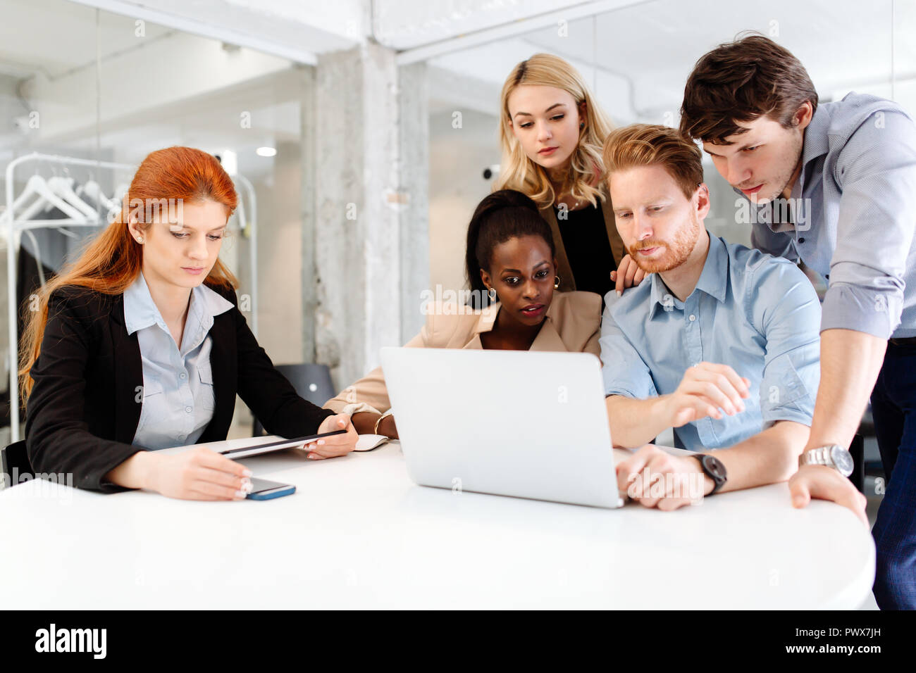 Business people collaborating in office and working on project together ...