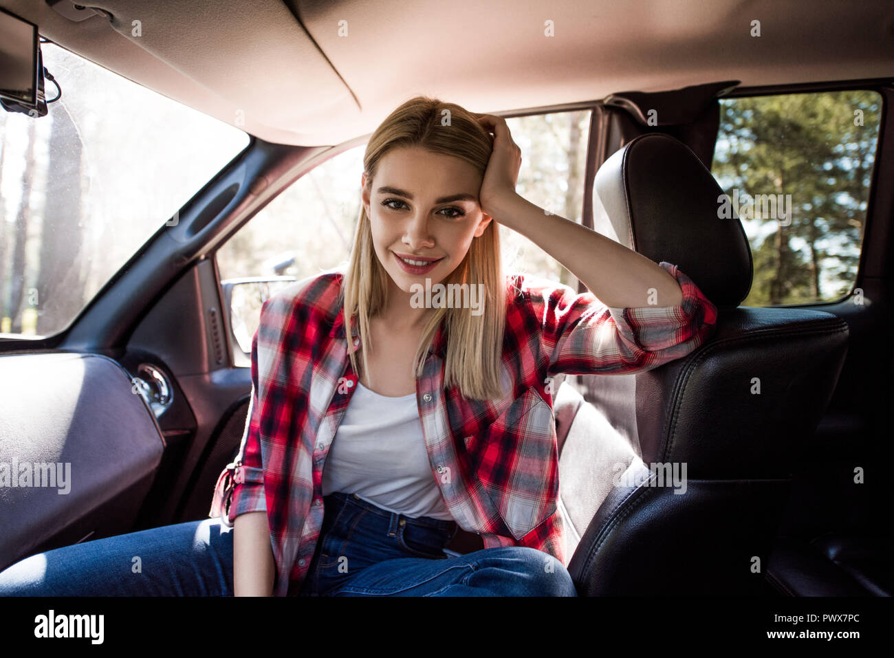beautiful smiling female driver sitting inside car Stock Photo - Alamy