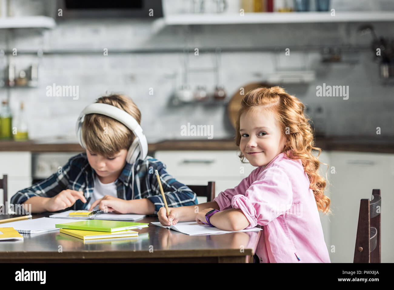adorable little kids doing homework together at kitchen Stock Photo - Alamy