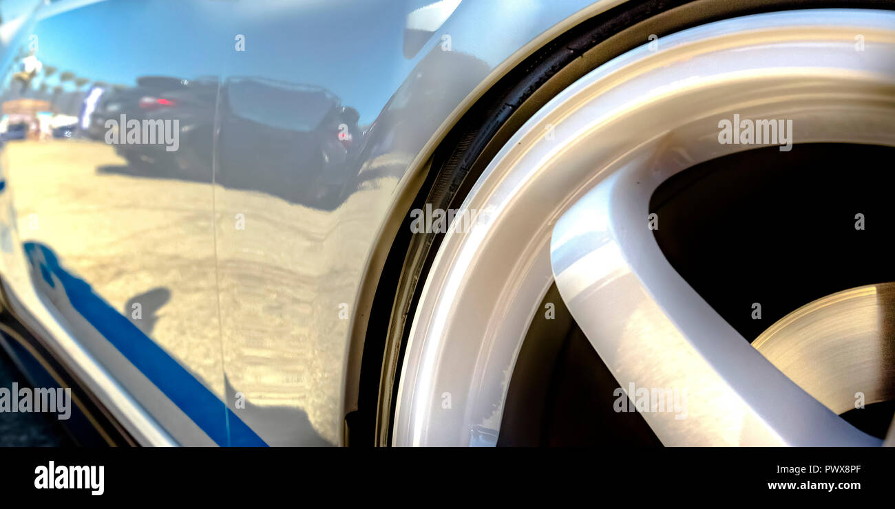 Wheel rim of a shiny white car with blue decal Stock Photo - Alamy