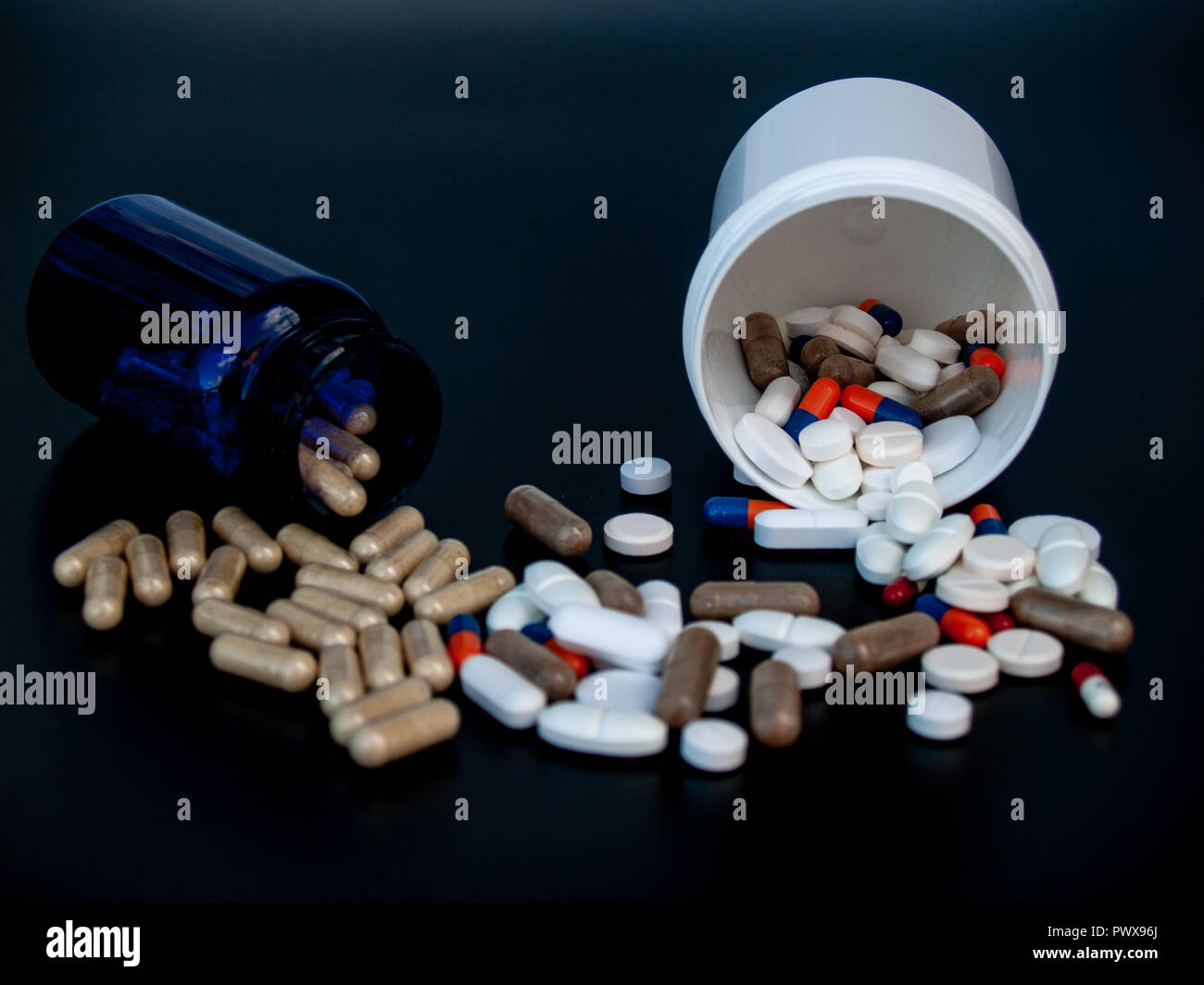 A pot of pills of different sizes, shapes and colors. Health concept ...
