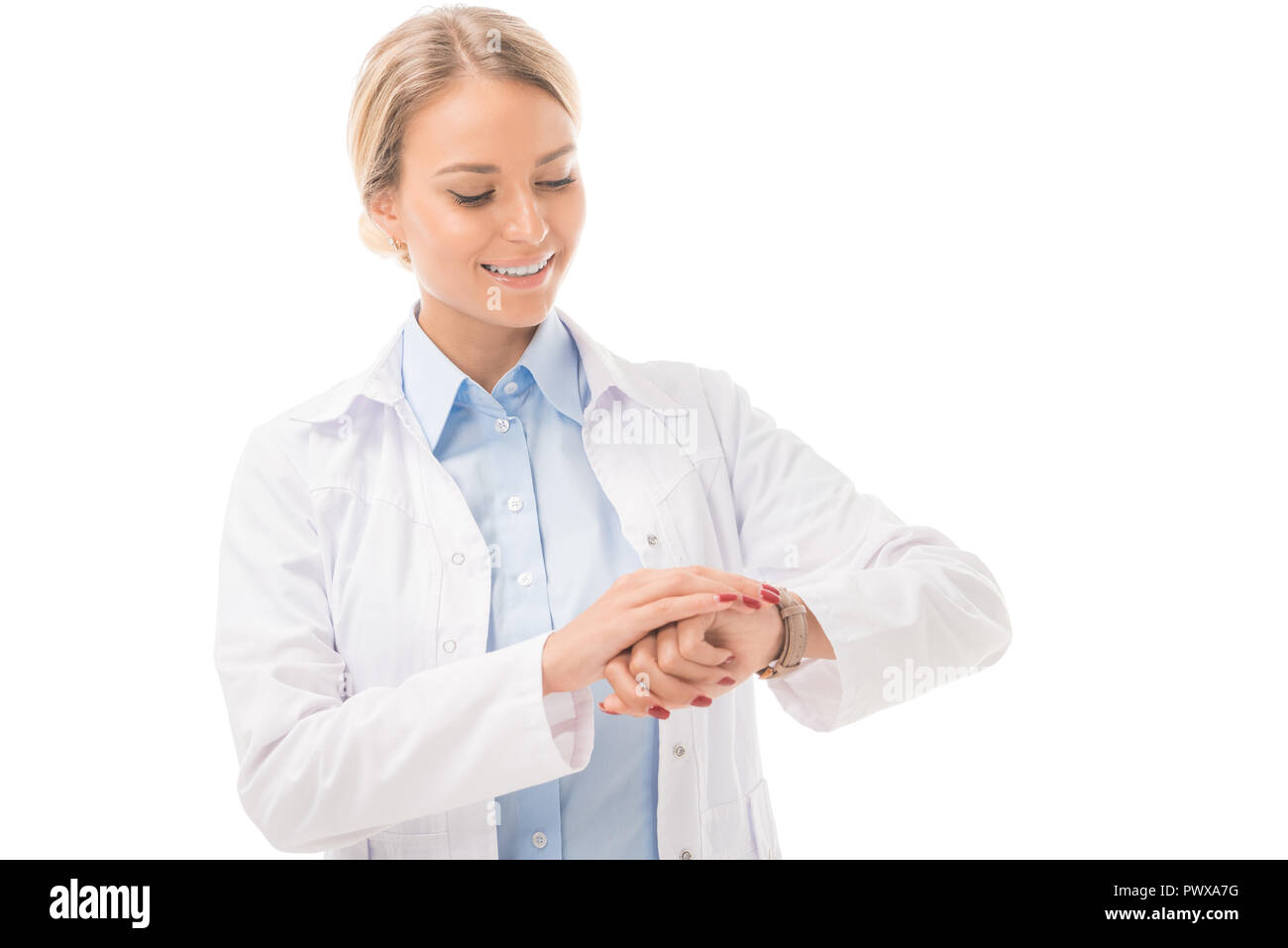 smiling young female doctor checking time with wrist watch isolated on ...