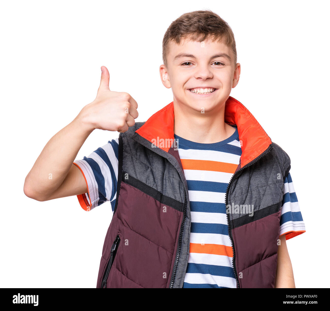 Emotional portrait of caucasian smiling teen boy making thumb up gesture. Handsome funny ...