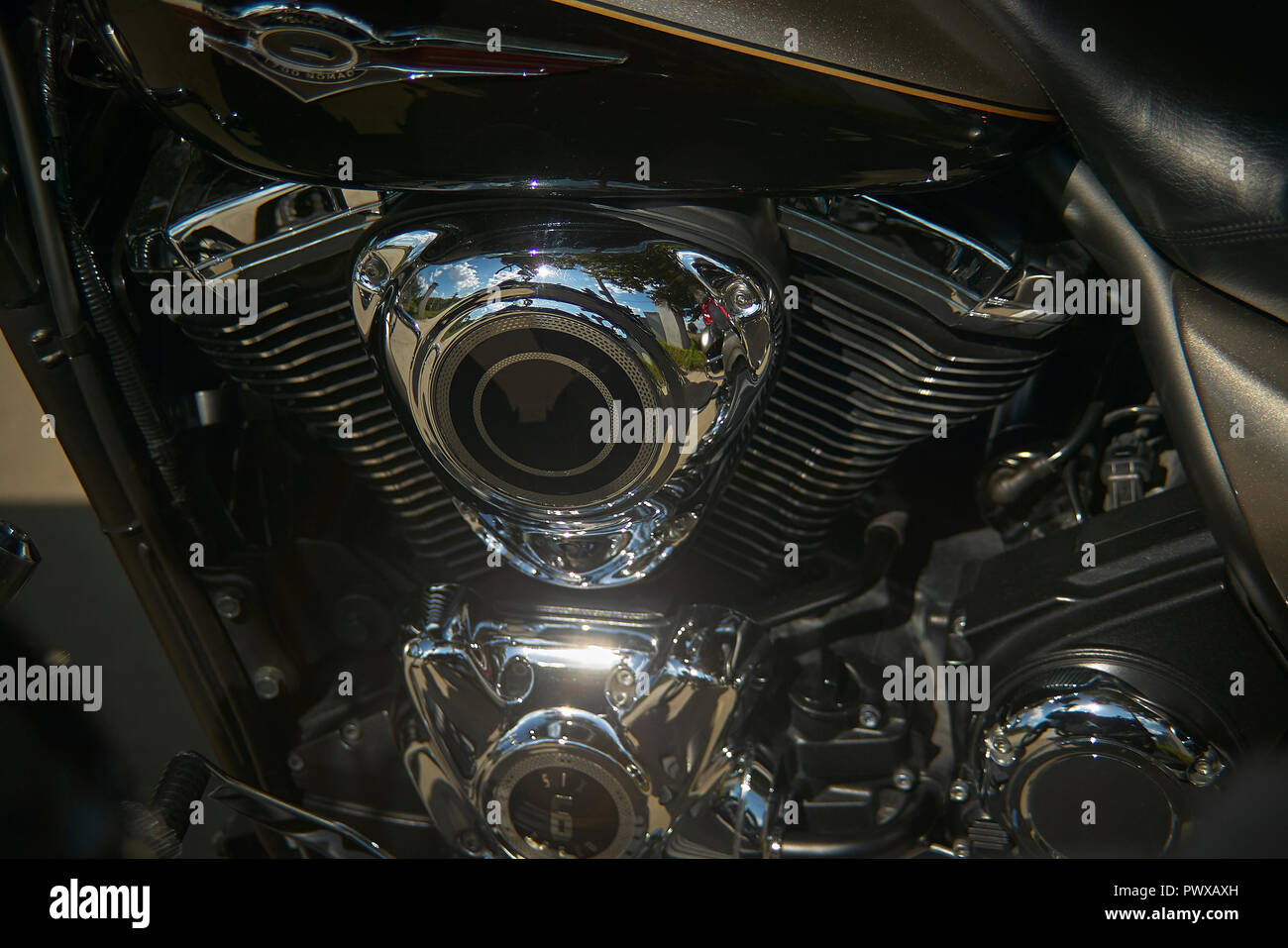 Engine of a colorful custom blue motorcycle, with glittering chromes, a ...