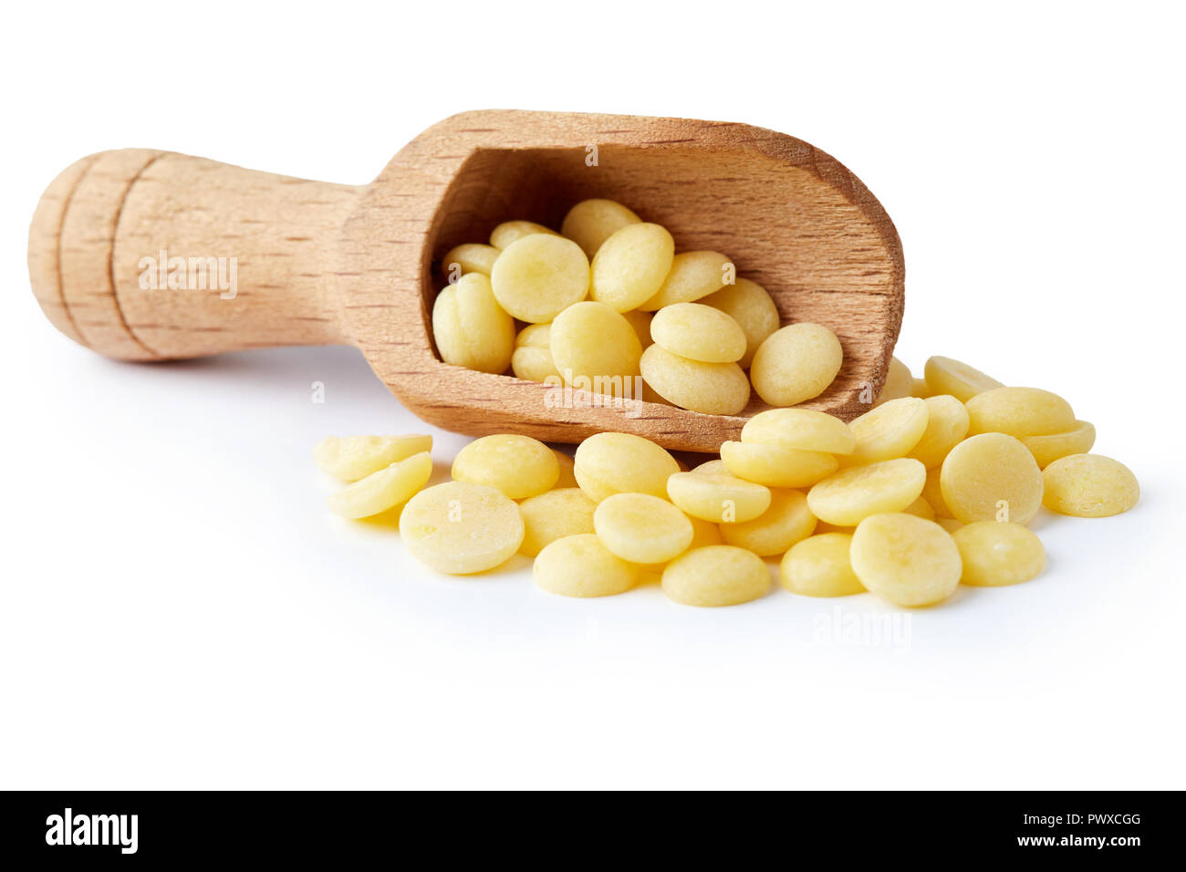 Organic cacao butter buttons (wafers) in wooden scoop isolated on white ...