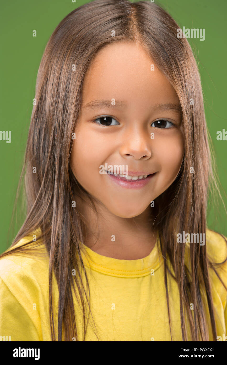 Happy teen girl standing, smiling isolated on trendy studio background ...