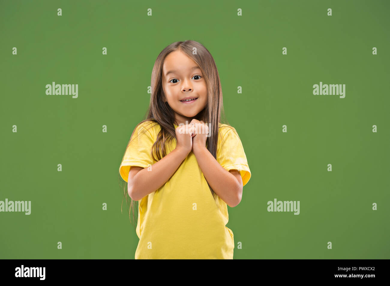 Happy teen girl standing, smiling isolated on trendy studio background ...