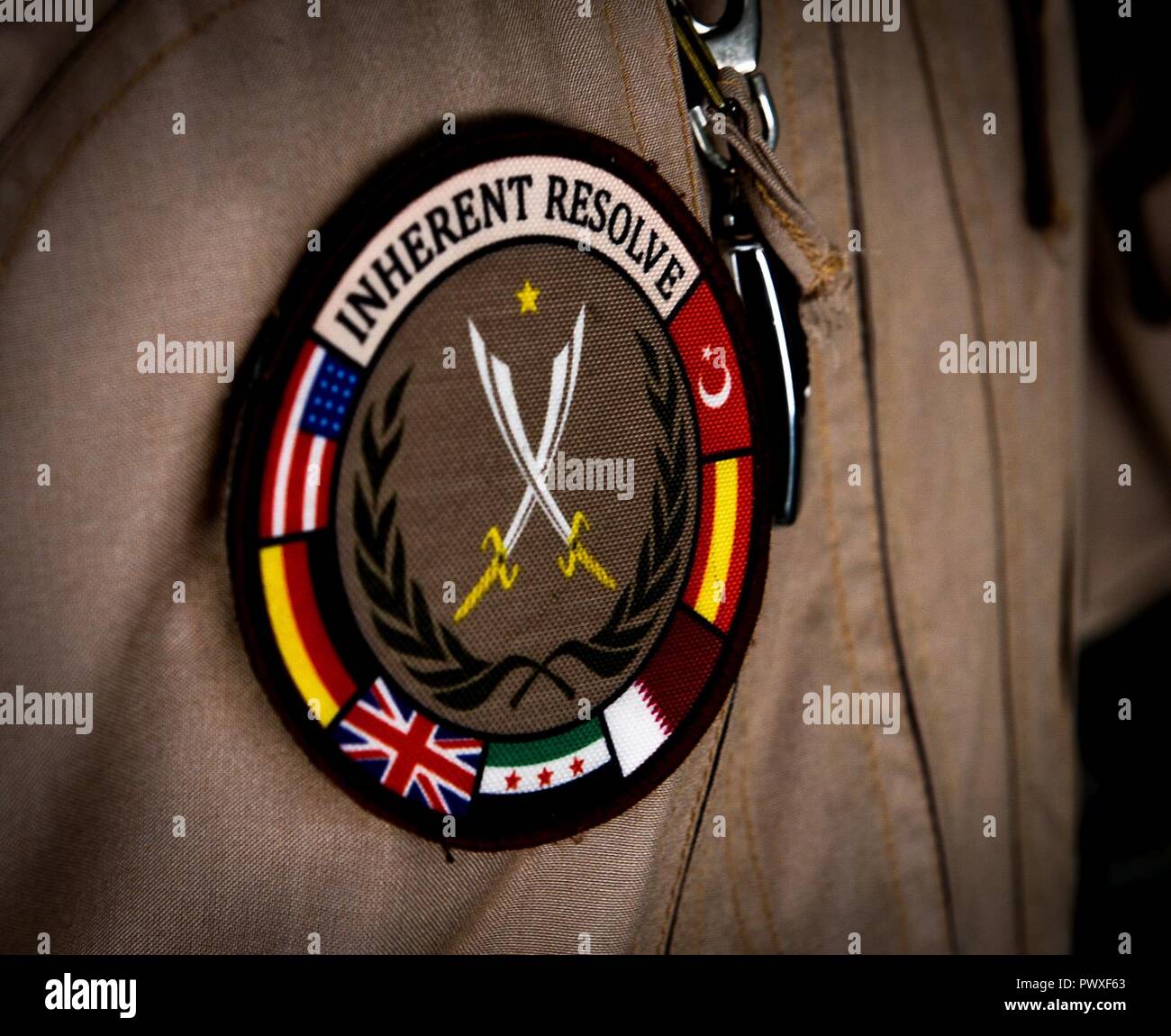 A Qatar Emiri Air Force member wears an Operation Inherent Resolve ...