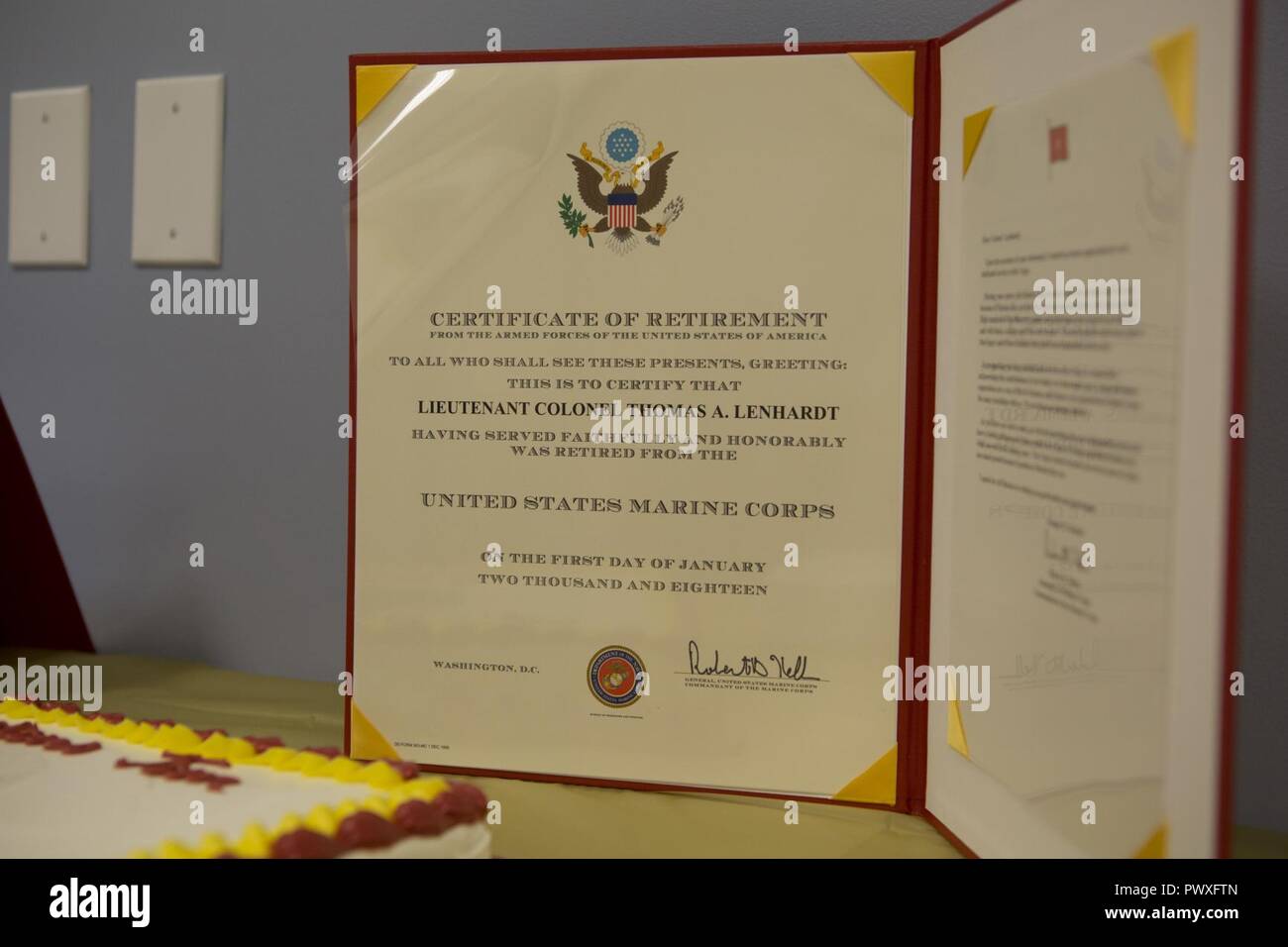 A certificate of retirement is displayed during the retirement ceremony ...