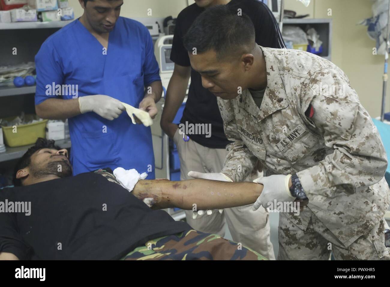 U.S. Navy Cmdr. Michael Mercado, right, the Task Force Southwest ...