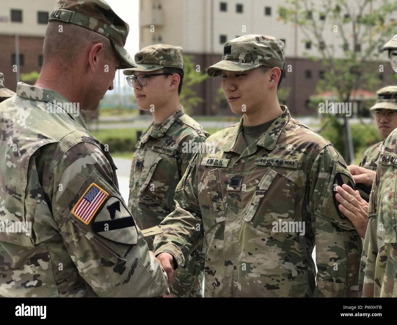 Lt. Col. Robert Kimmel shakes the hand if KATUSA Cpl. Dohoen Kim after ...