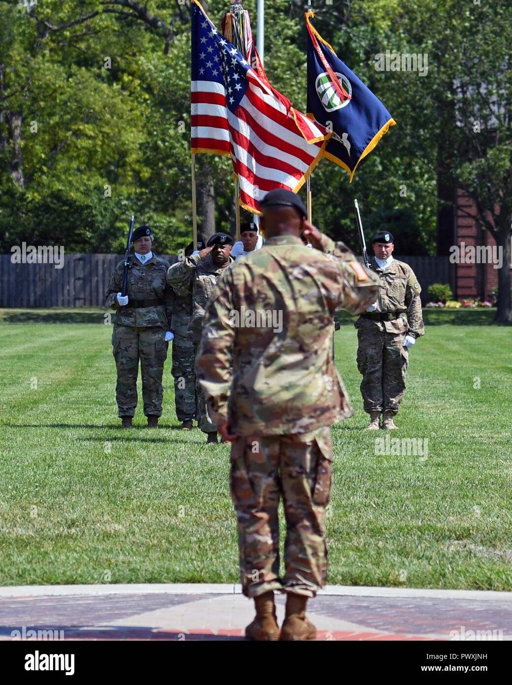 Command Sgt. Maj. Dana S. Mason, Jr. (center) salutes the formation ...