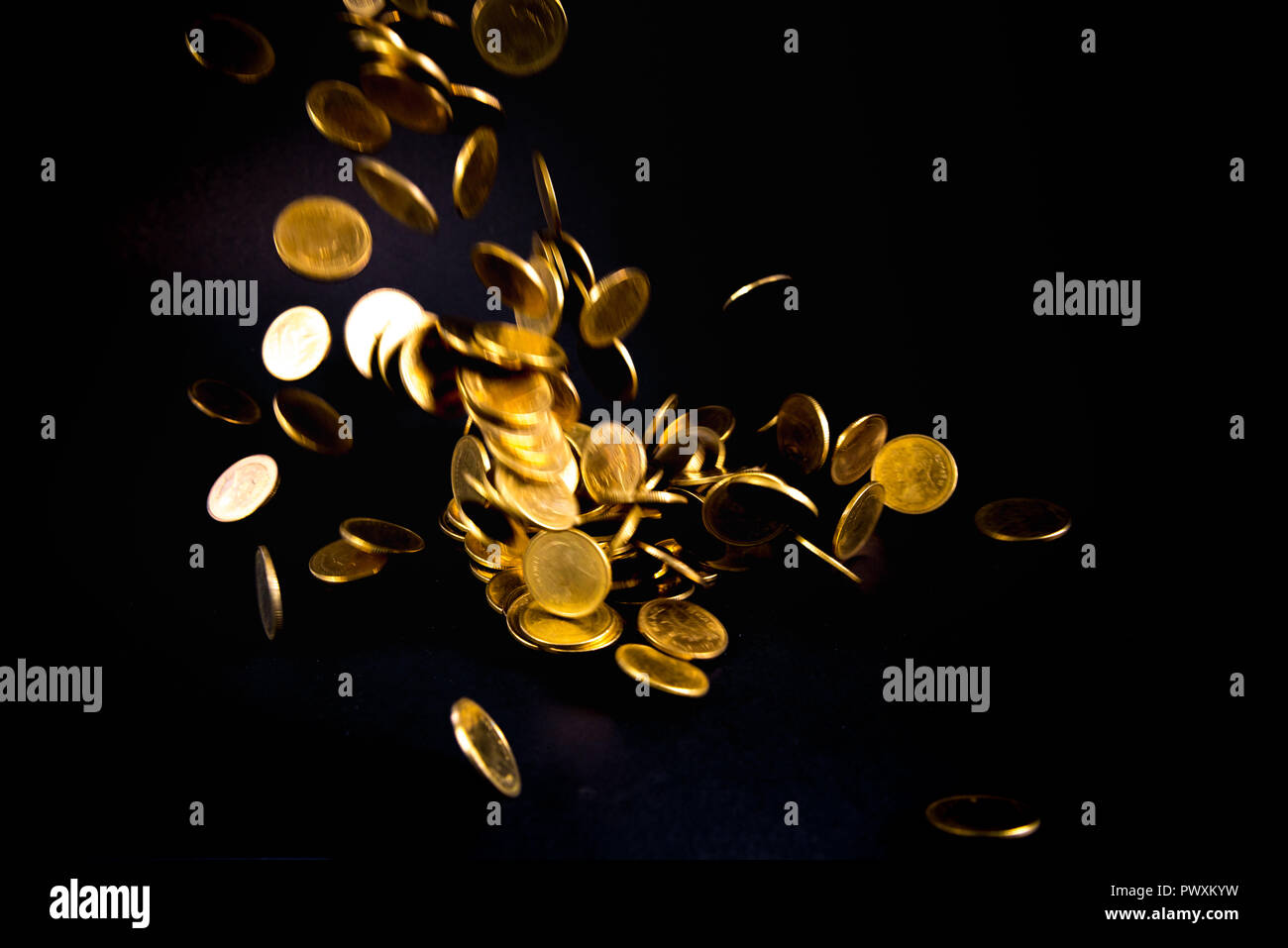 Falling gold coins money in dark background, business concept idea ...