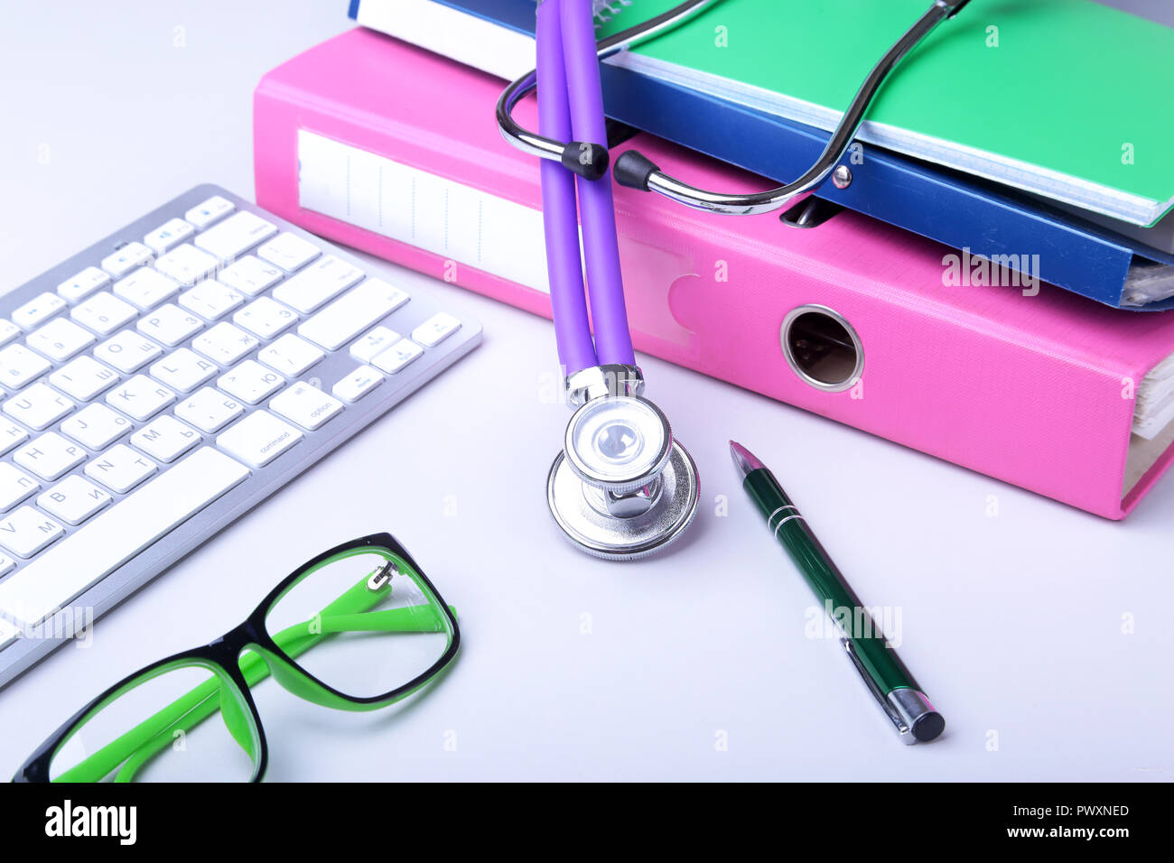 Medical record concept with stethoscope over pile of folders. Keyboard ...