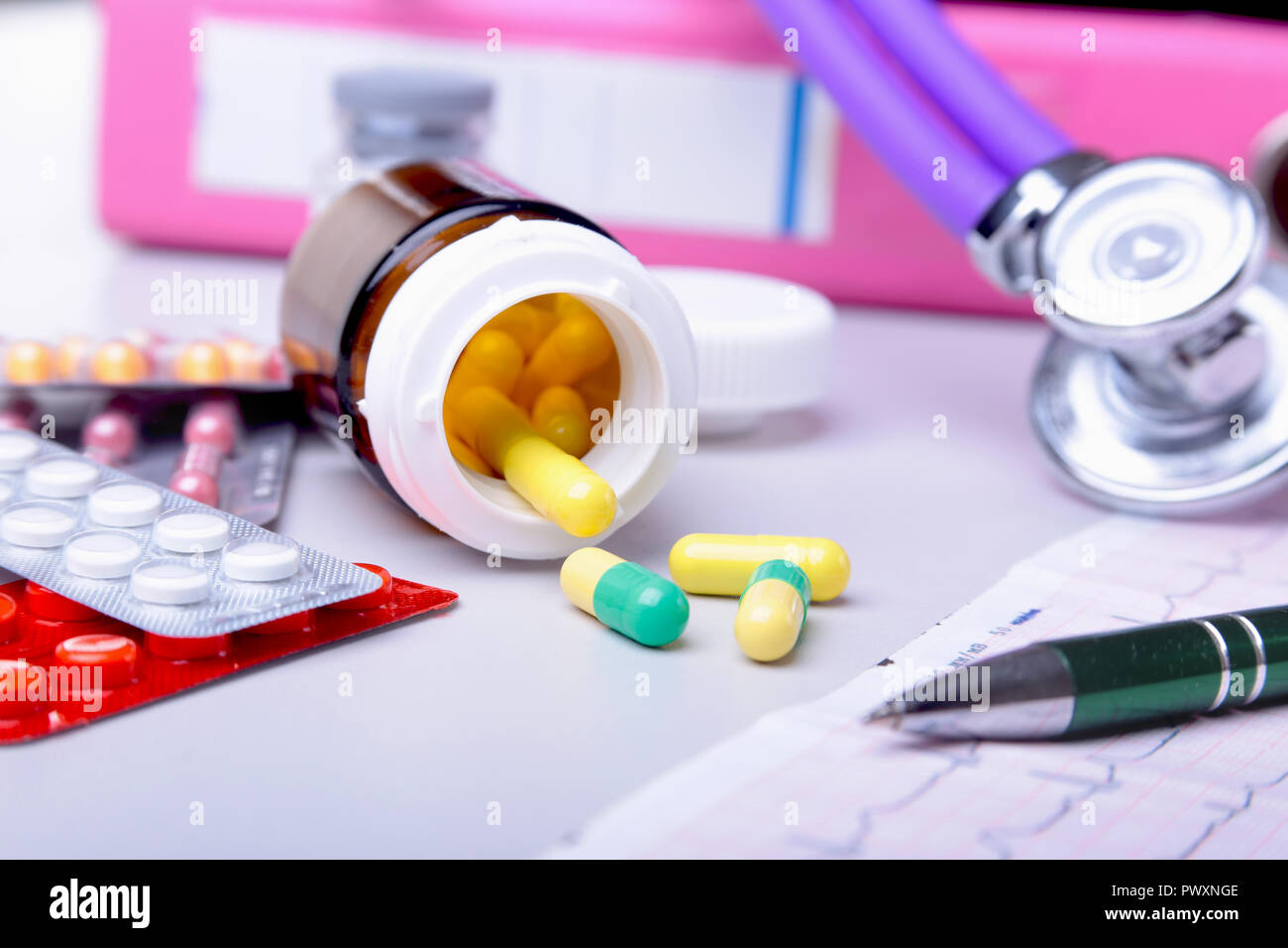 Close-up stethoscope lying on RX prescription with assorted pills ...