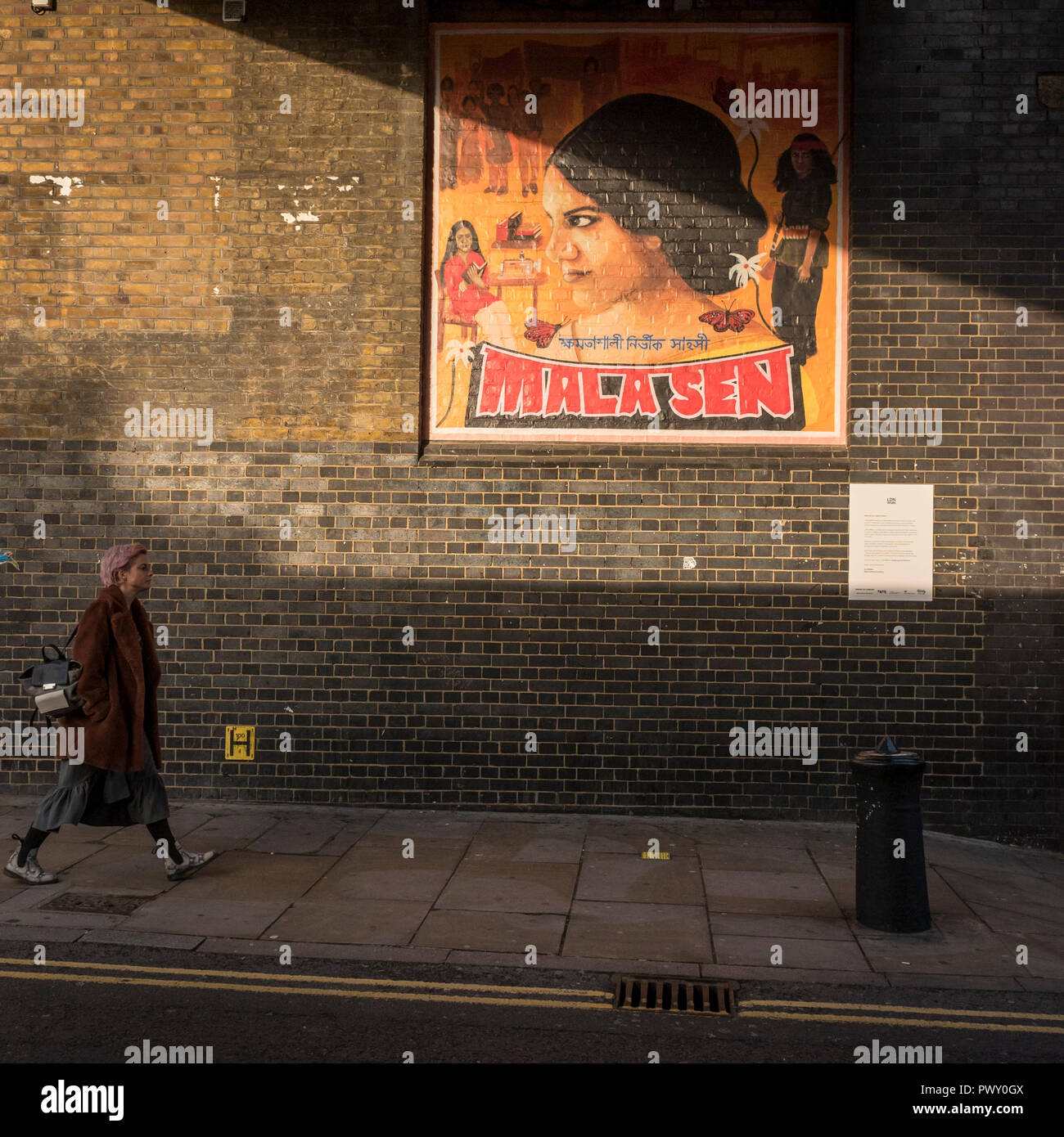 London, UK. 18 October 2018. A woman walks by a newly unveiled artwork ...