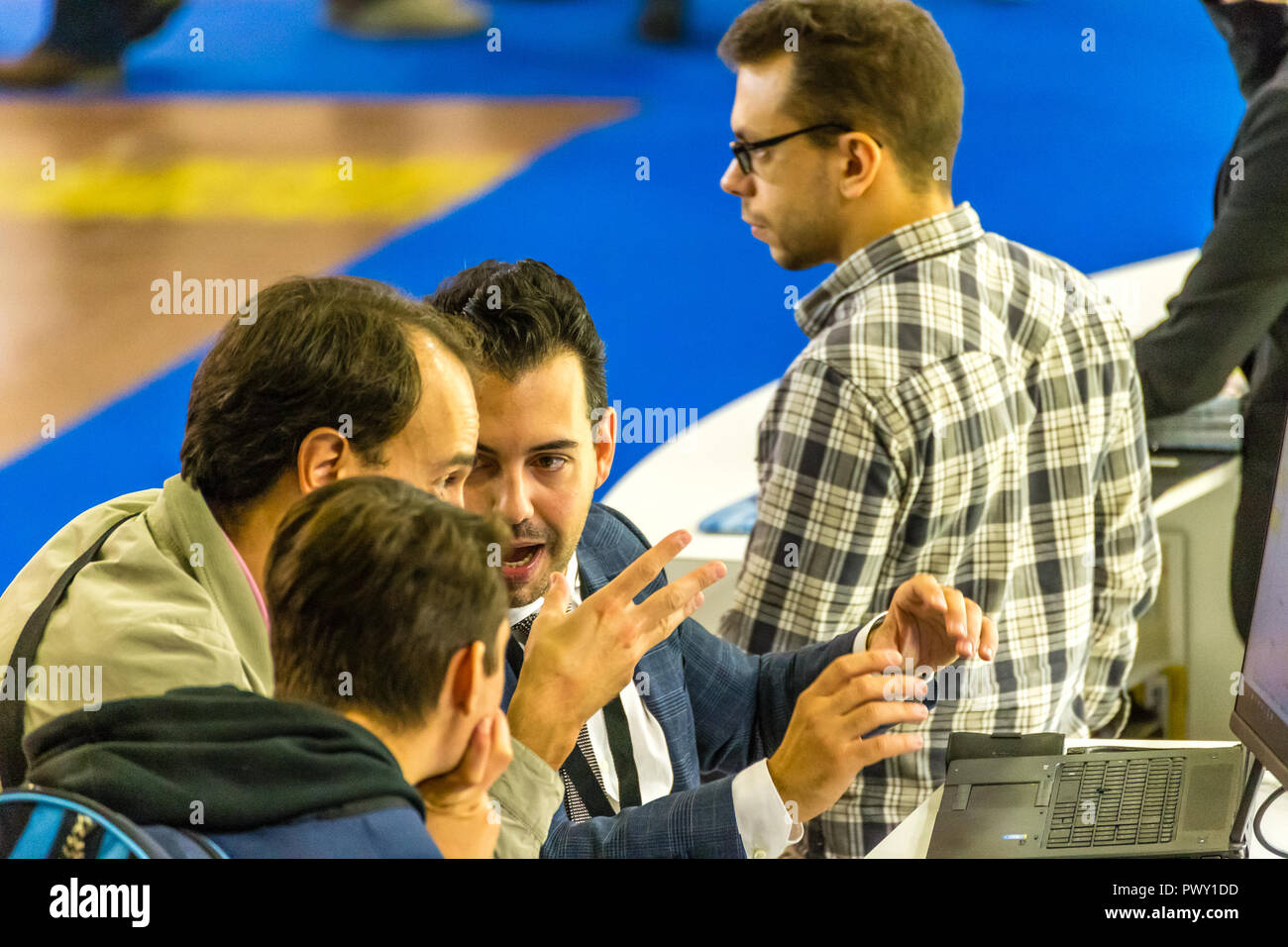 Bologna, Italy. 17th October, 2018. Booth presenter welcomes visitors ...