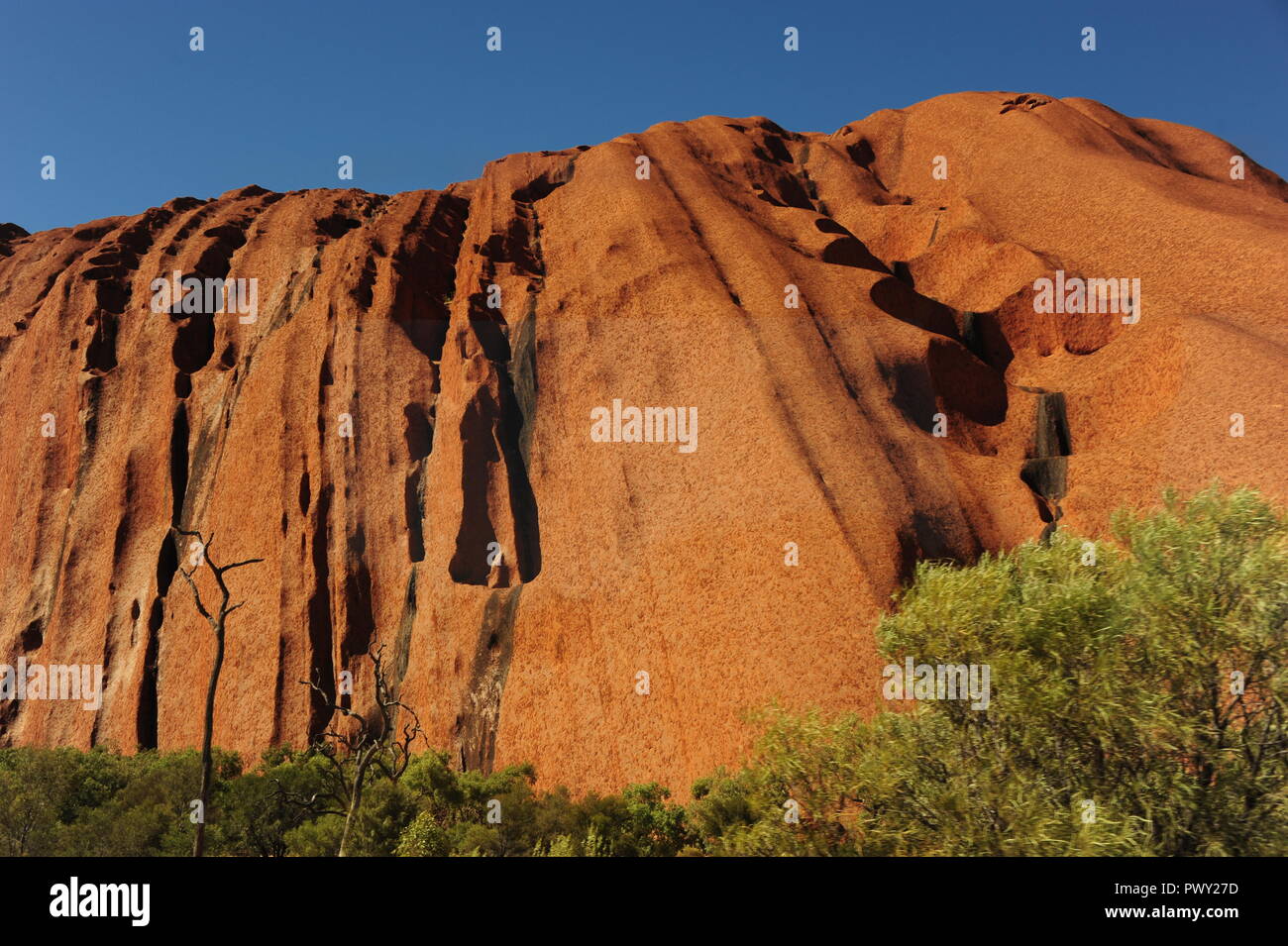 Impressive rock formation of the Uluru (Ayers Rock) with caves and ...