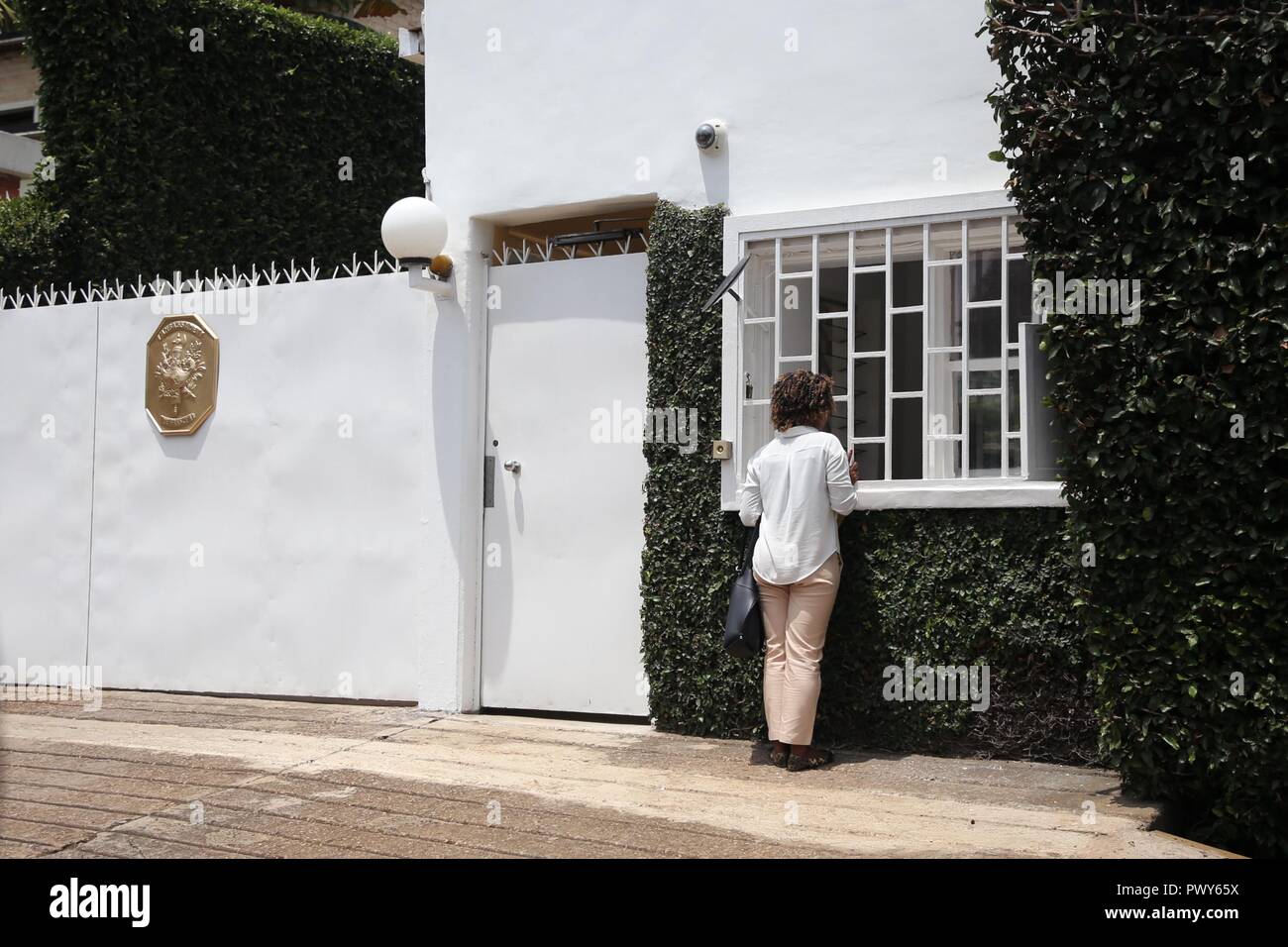 Kigali. 18th Oct, 2018. A person stands outside the French Embassy in ...