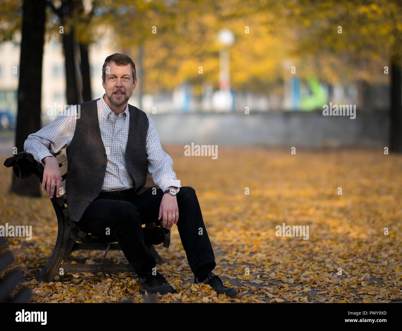 Dresden, Germany. 18th Oct, 2018. Opera singer Georg Zeppenfeld sits on ...