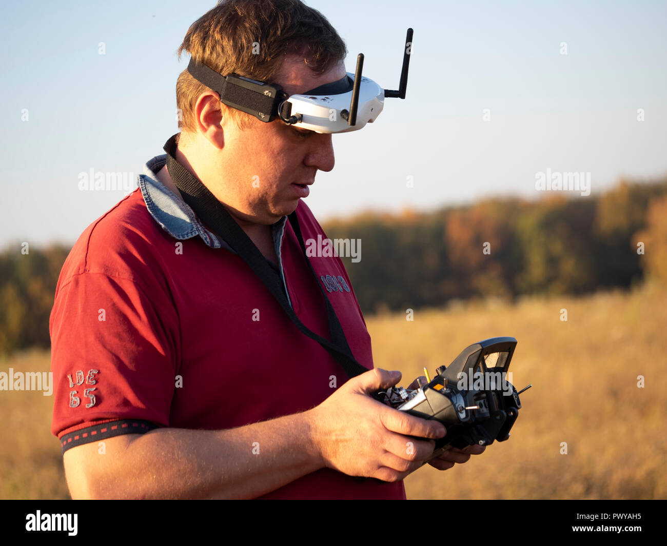 Man seen operating a drone with remote control Stock Photo - Alamy