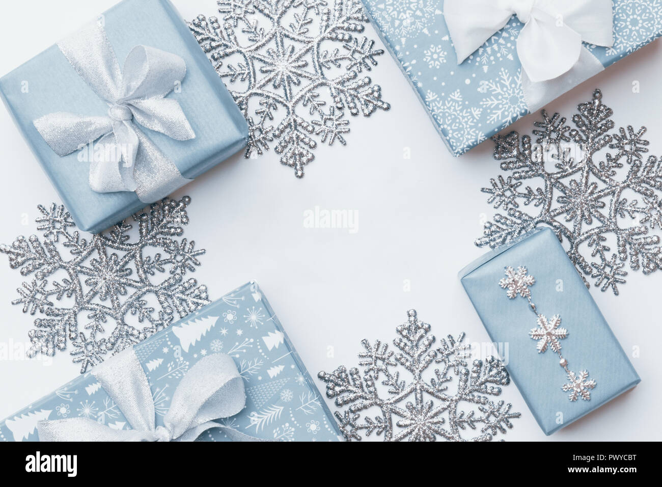 Beautiful christmas gifts and silver snowflakes isolated on white ...