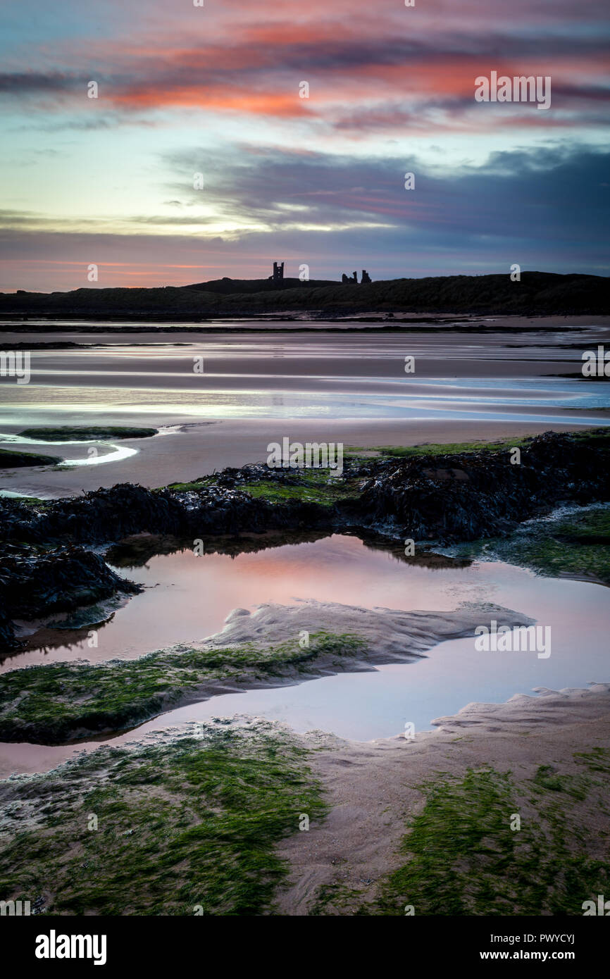 Dusk over Embleton Bay looking south to Dunstanburgh Castle Stock Photo ...