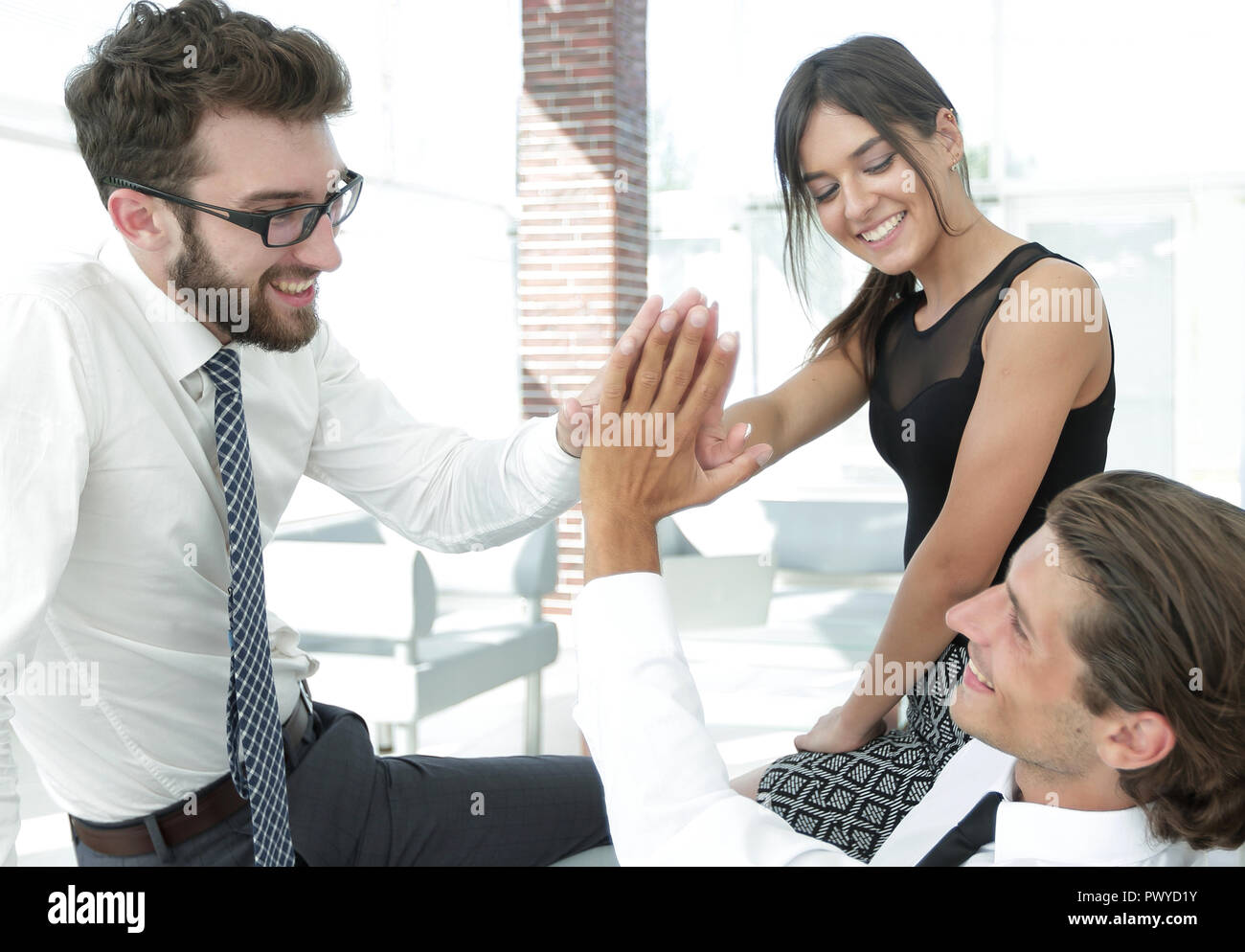 Team members high five hi-res stock photography and images - Alamy