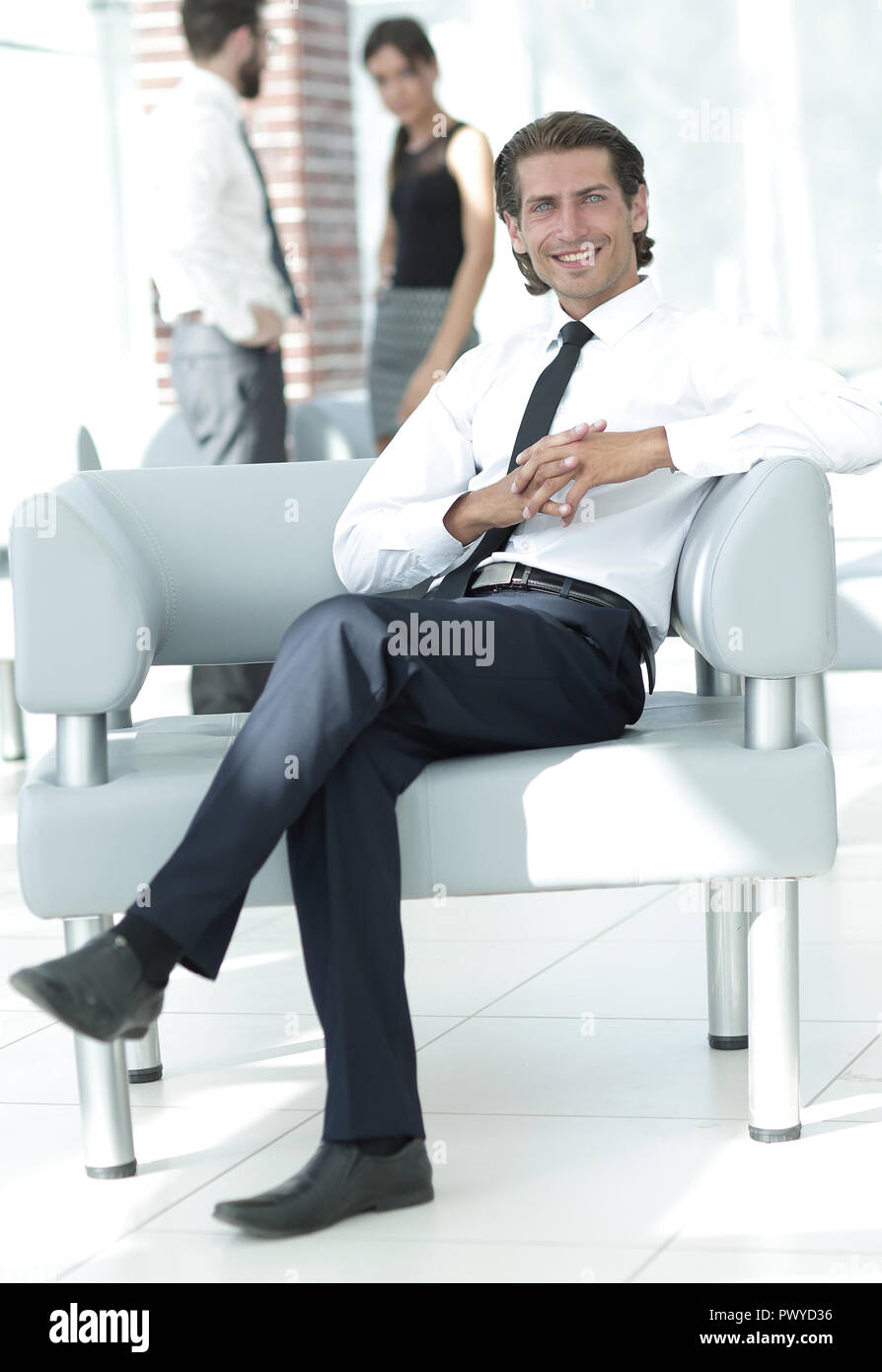 smiling businessman sitting in office chair Stock Photo - Alamy