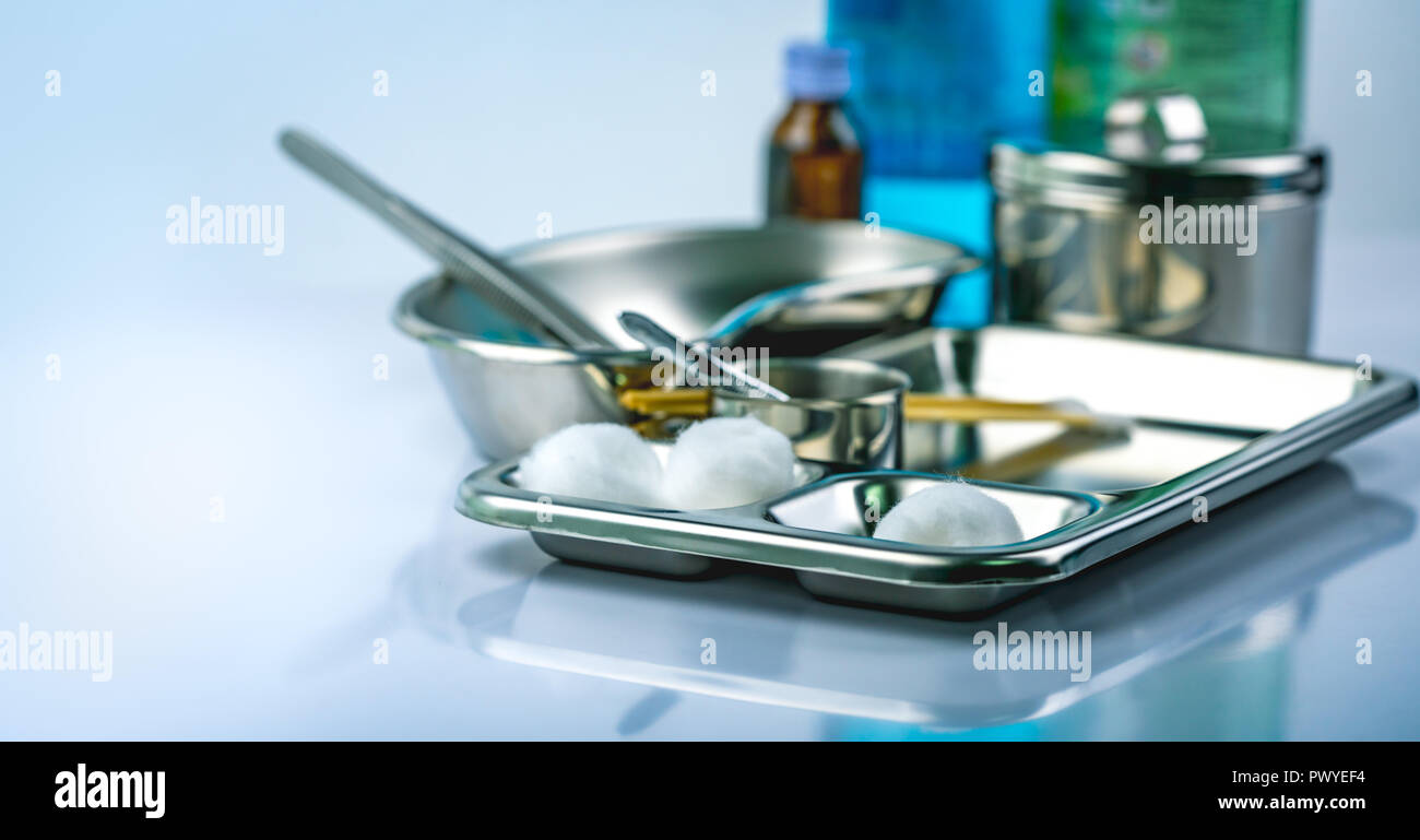 Wound care dressing set on stainless steel plate. White cotton ball ...