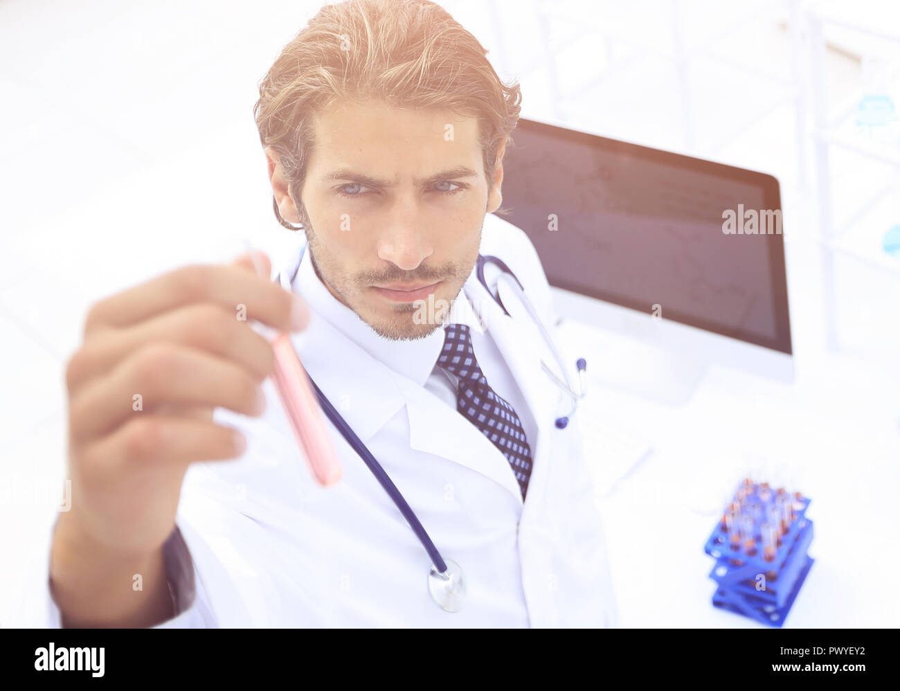 Technician holding and examining test tubes hi-res stock photography ...