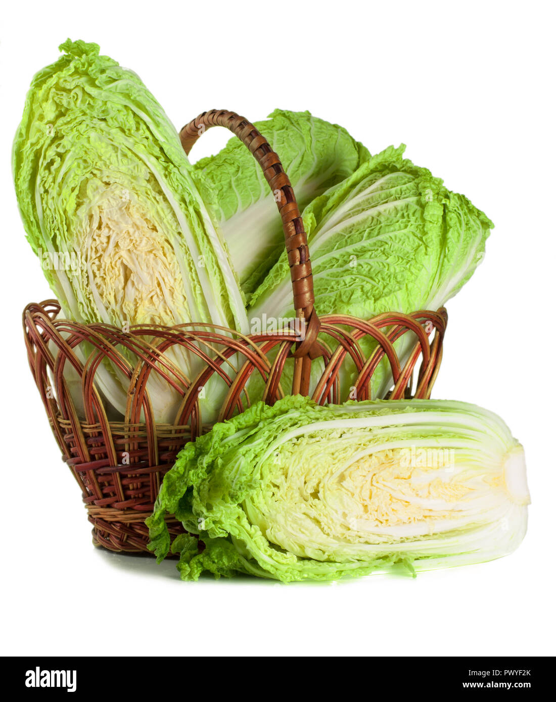 chinese cabbage and half in a wicker basket isolated on white ...