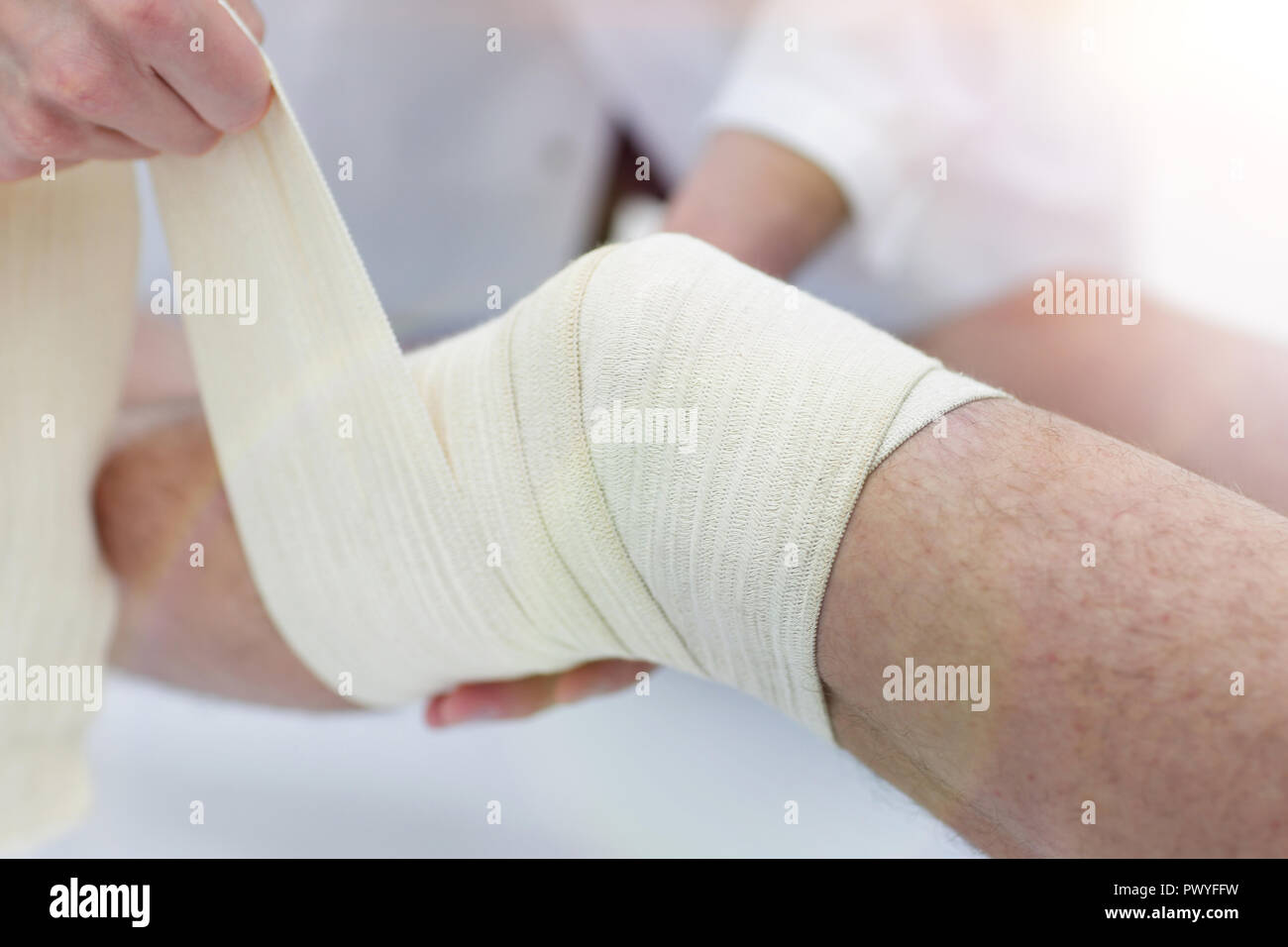 closeup. doctor bandaging a patient's leg Stock Photo - Alamy