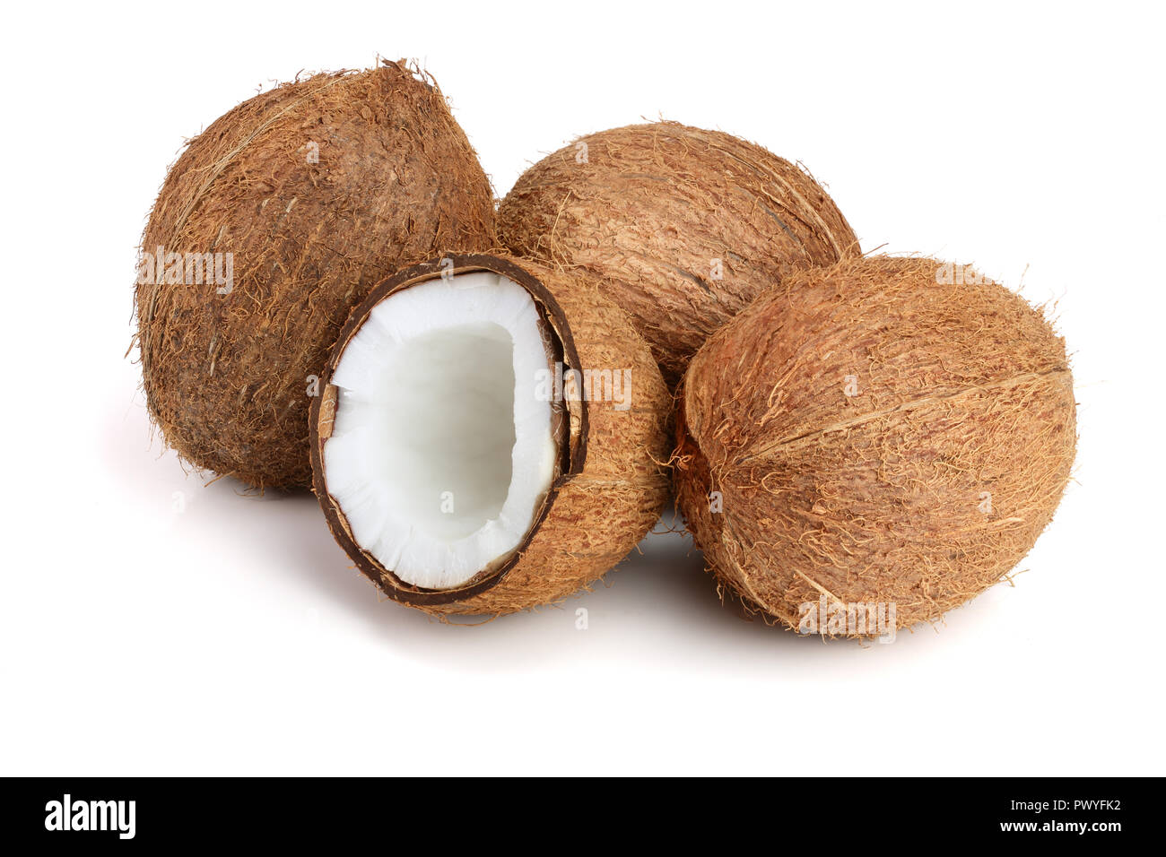 three whole coconut and half isolated on white background Stock Photo ...
