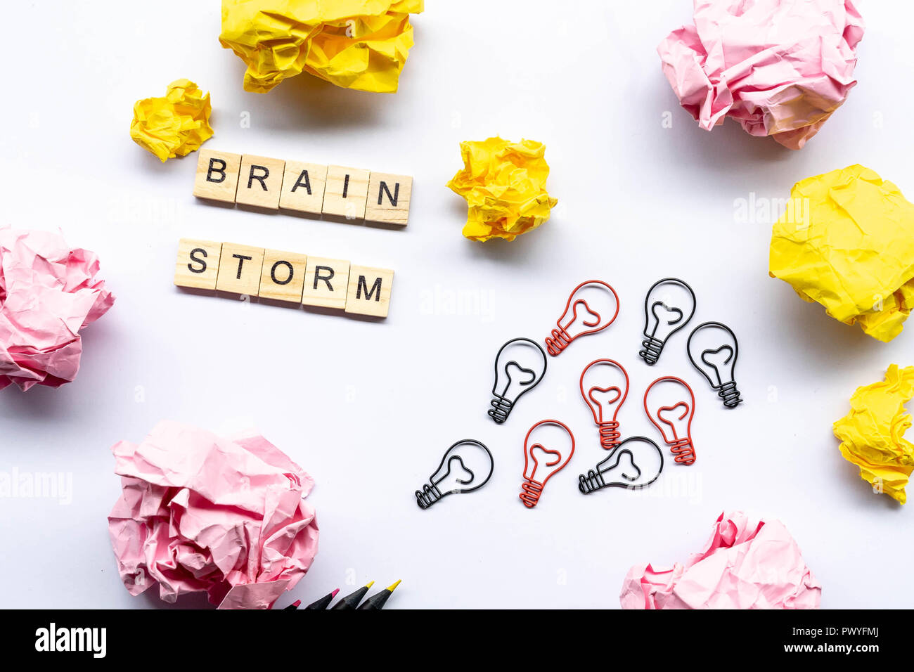 Brainstorm concept word on wooden block surrounded by crumpled papers ...