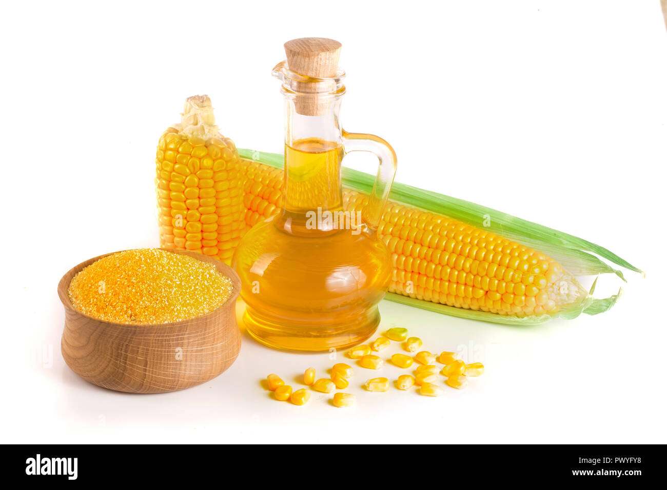 Corn oil in decanter, fresh corn cobs and grains isolated on white ...