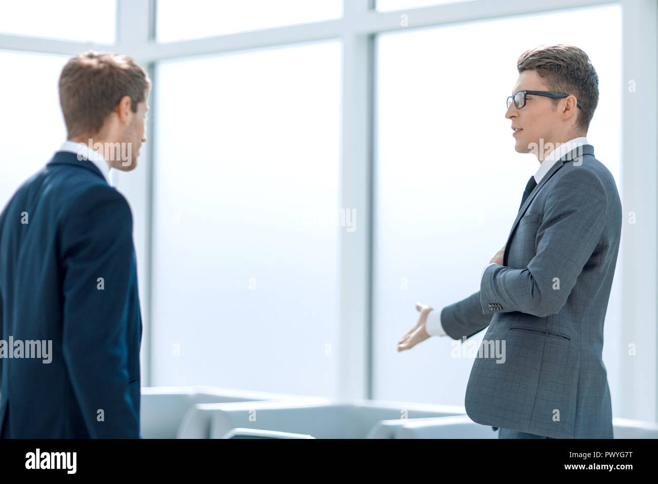 business colleagues talking standing in the office Stock Photo - Alamy