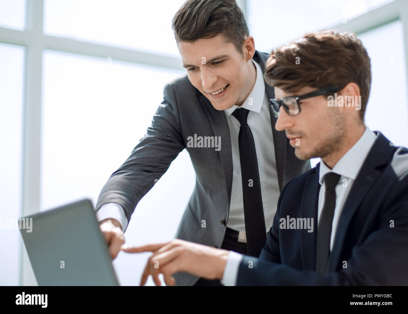 employees use a laptop to check the information they need Stock Photo ...