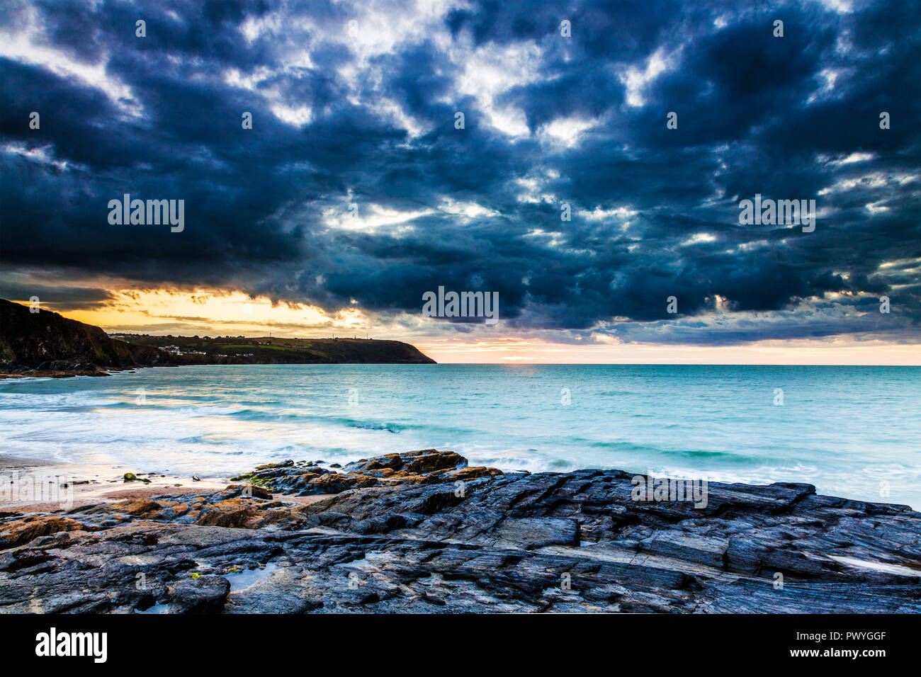 Sunset over the beach at Tresaith in Ceredigion, Wales, looking towards ...
