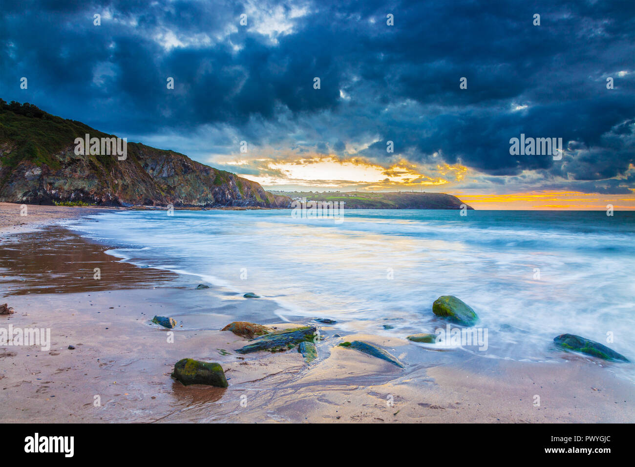 Sunset over the beach at Tresaith in Ceredigion, Wales, looking towards ...
