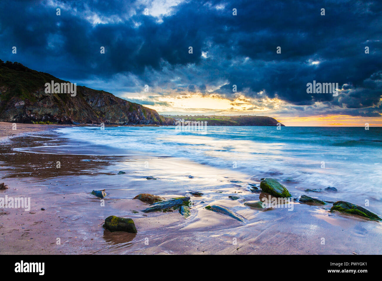Sunset over the beach at Tresaith in Ceredigion, Wales, looking towards ...