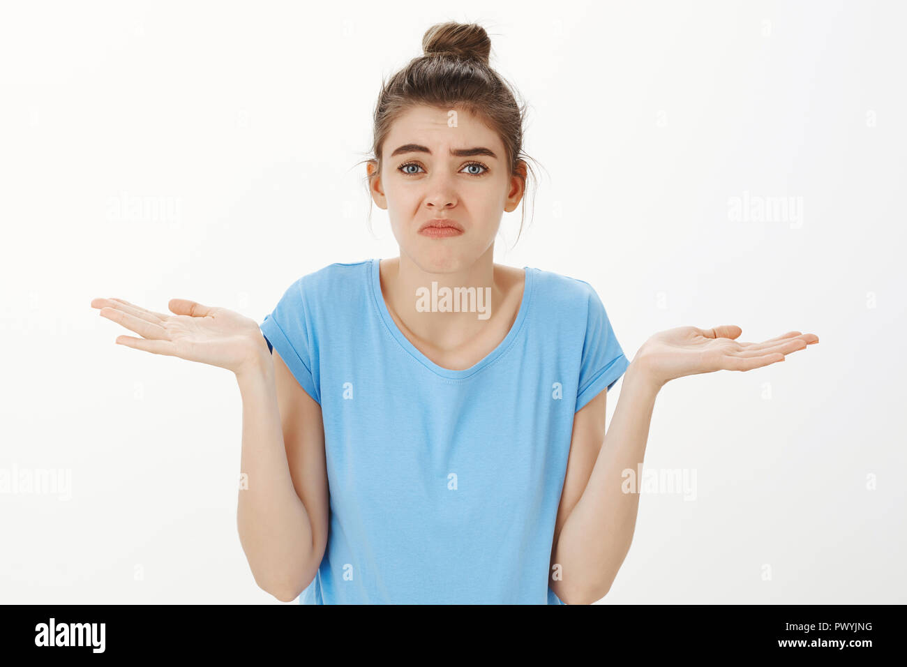 Girl feeling desperate stuck in confusing situation, shrugging and ...