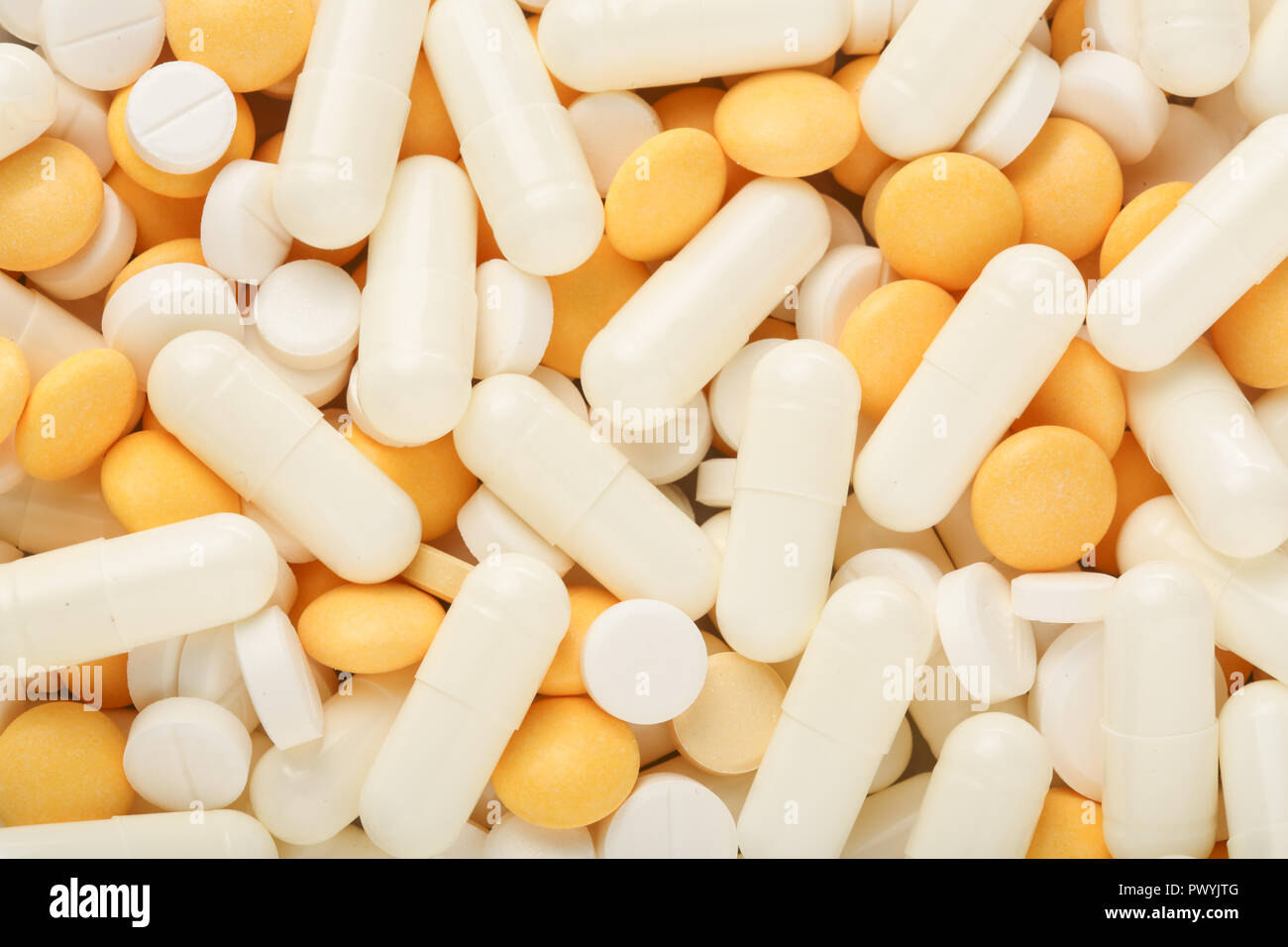 white and yellow pill capsule isolated on white background. Top view ...