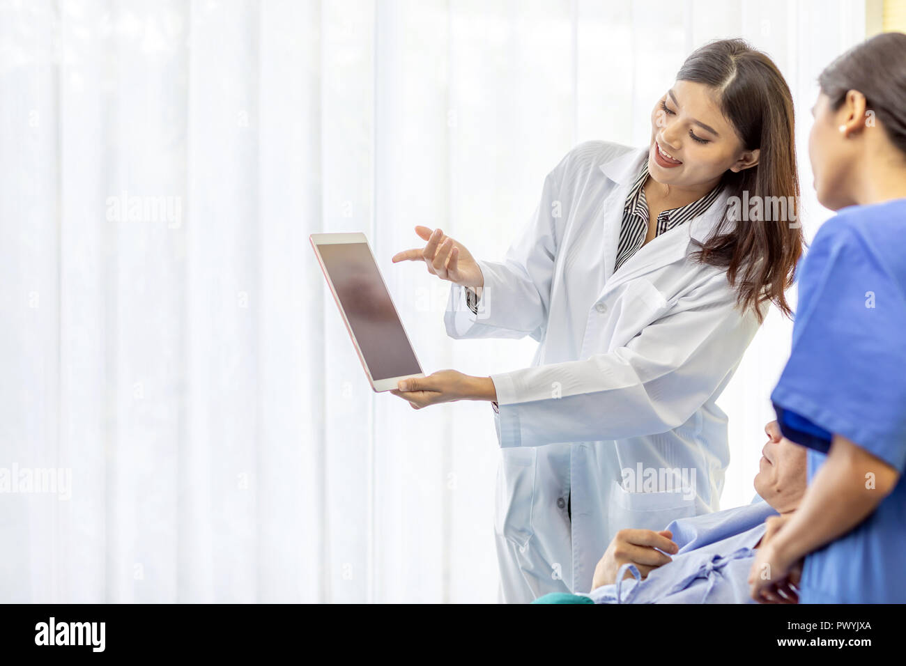 Doctor explaining treatment of patient to nurse using tablet Stock ...