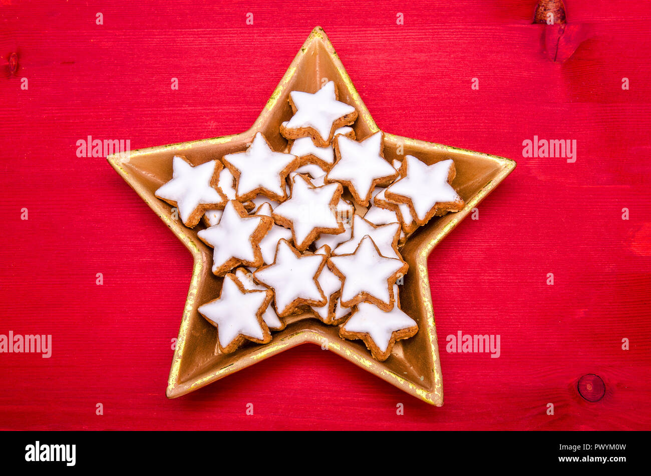 star shaped christmas cookies in a star shaped golden bowl on a red ...