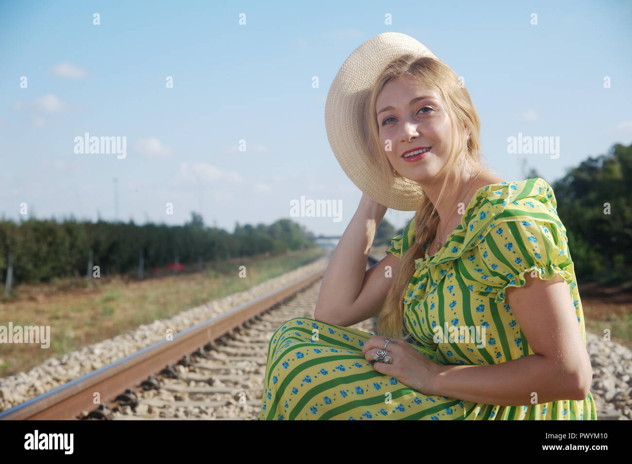 an amazing young blonde lady wait to locomotive, try stop train Stock ...