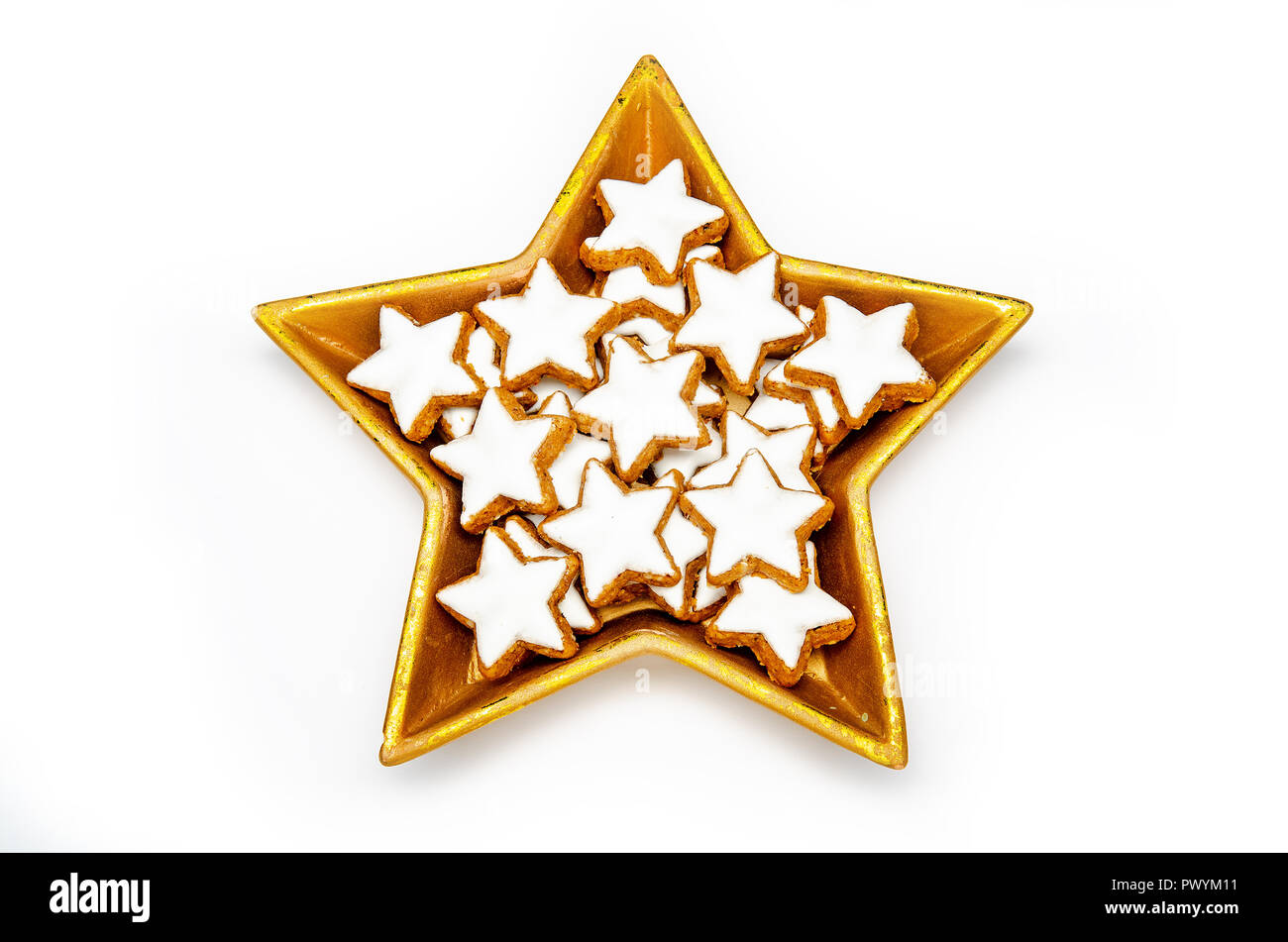 star shaped christmas cookies in a star shaped golden bowl on a white ...