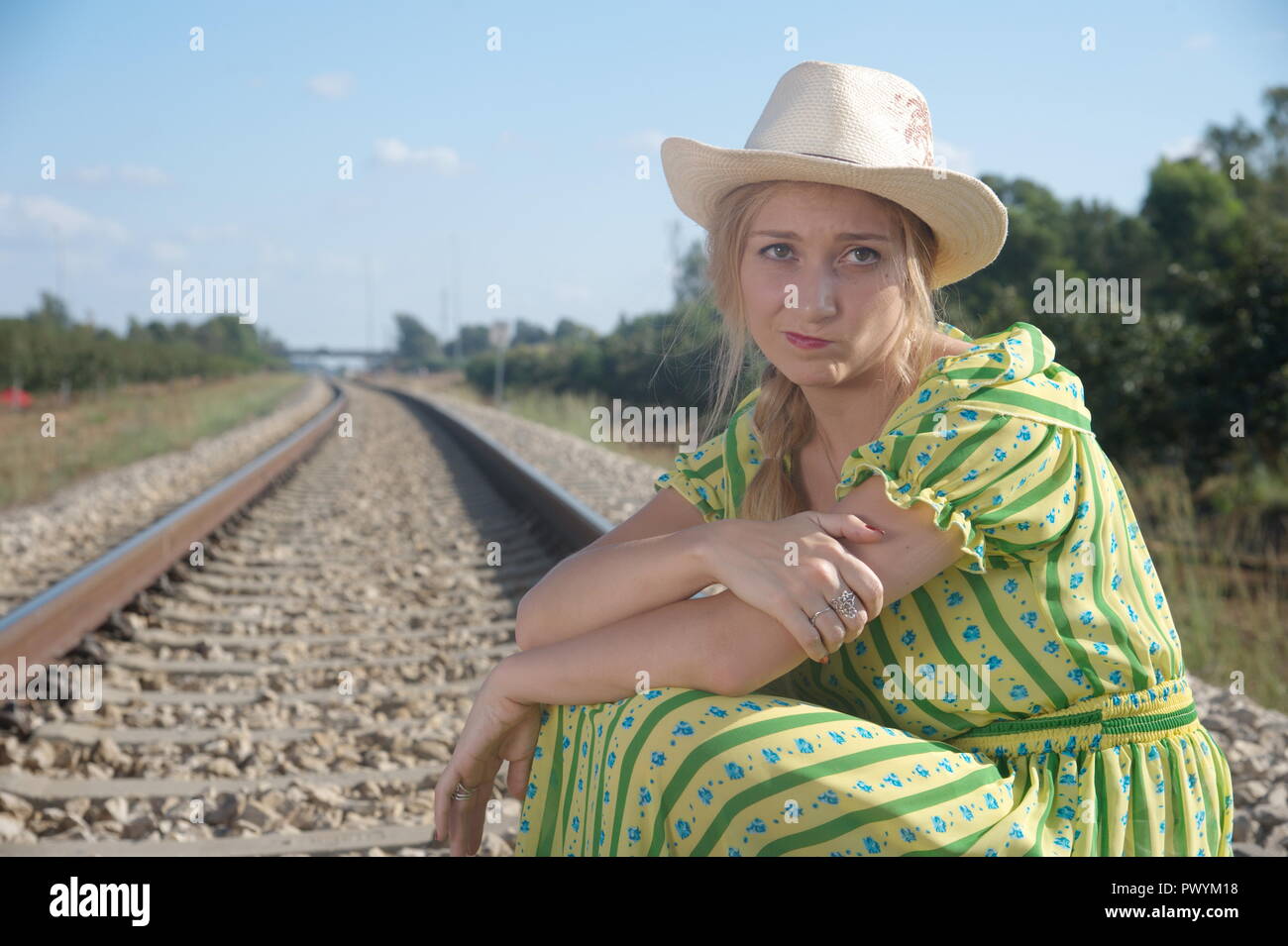 an amazing young blonde lady wait to locomotive, try stop train Stock ...