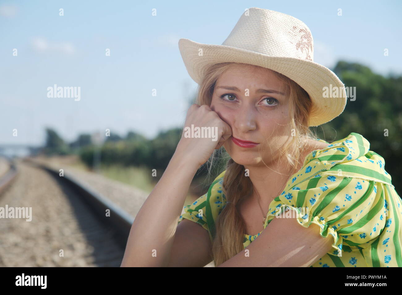 an amazing young blonde lady wait to locomotive, try stop train Stock ...