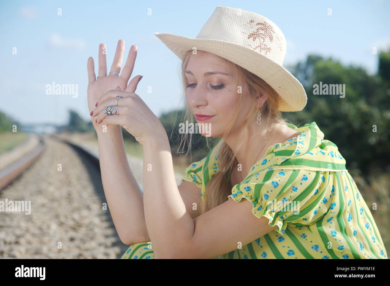 an amazing young blonde lady wait to locomotive, try stop train Stock ...